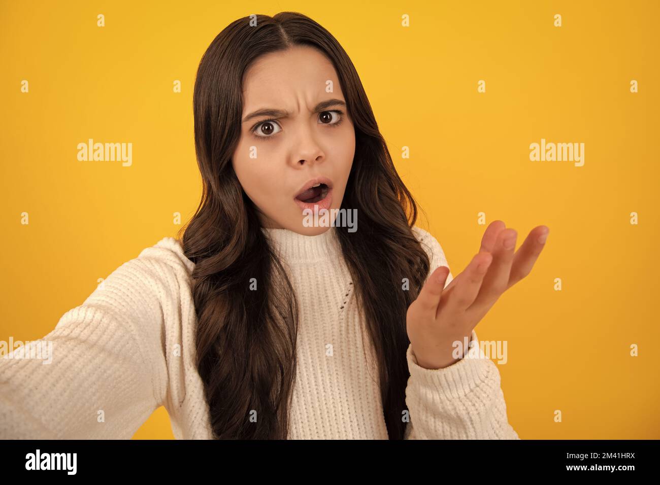 Teen girl making selfie posing on yellow background. Fashion teenager ...