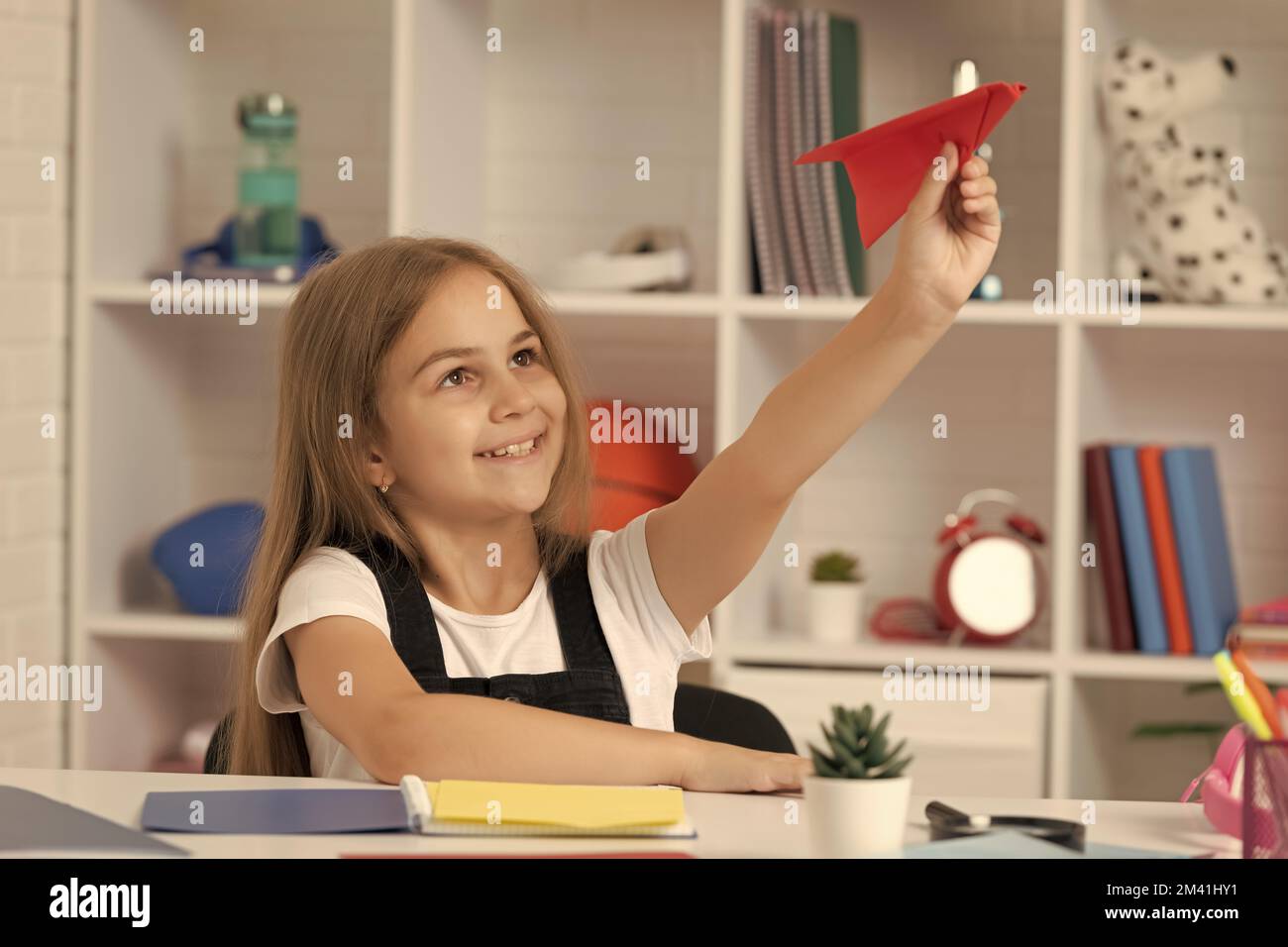 cheerful kid play with paper plane in school classroom Stock Photo - Alamy