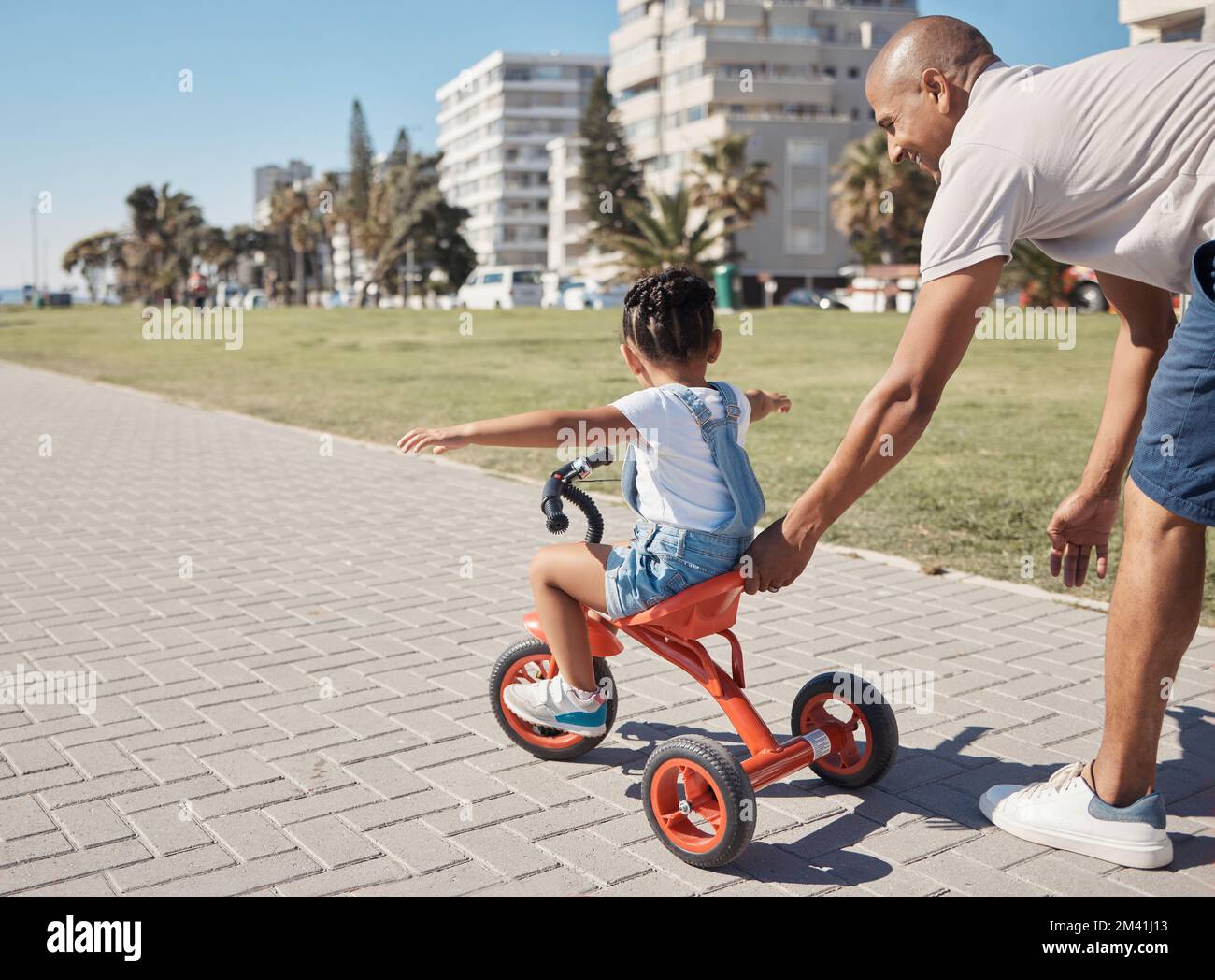 Child, girl or father pushing bike on city promenade for riding ...