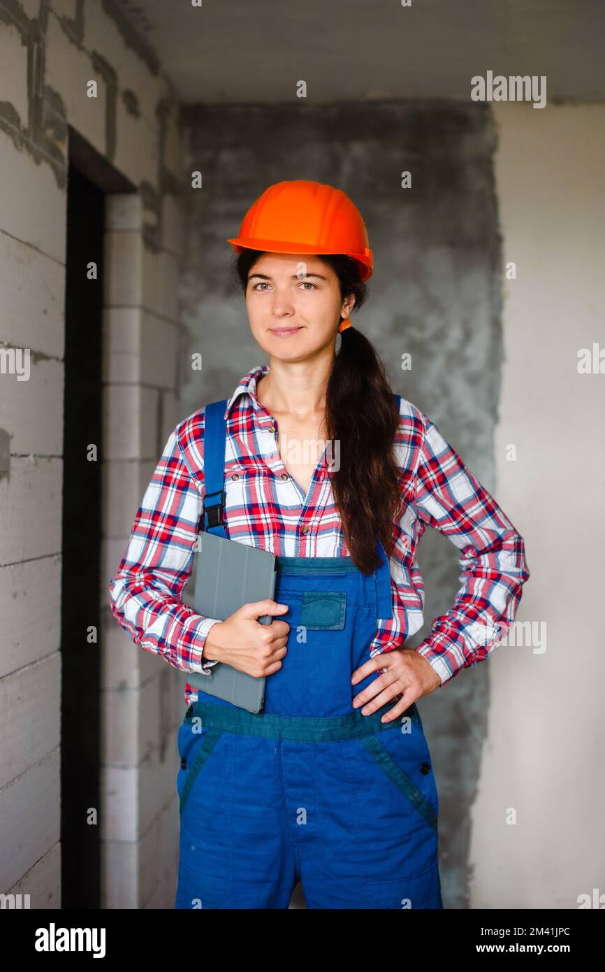 Construction maintenance engineer woman in uniform and protective ...