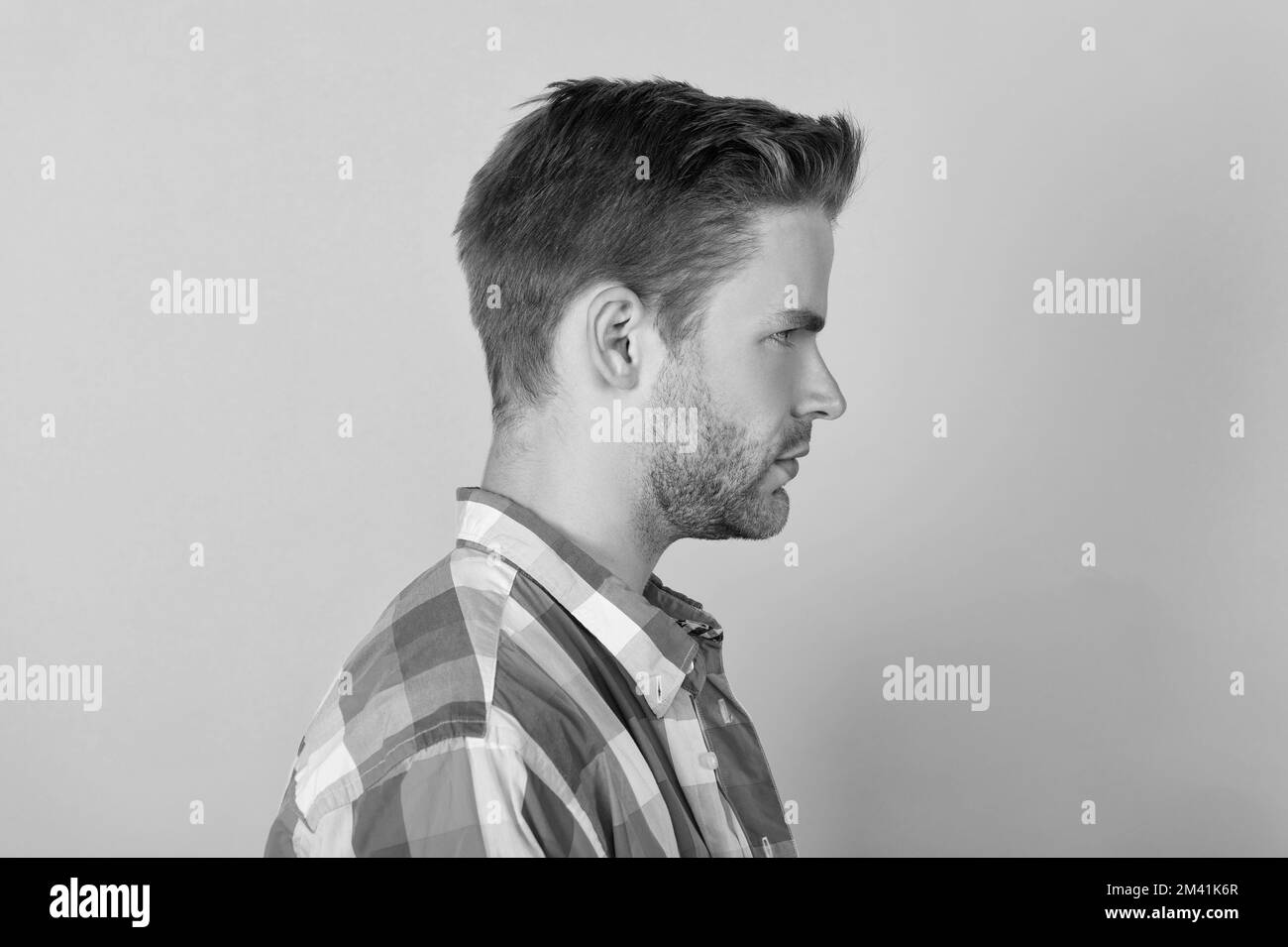 Handsome and unshaven. Young man in profile. Profile portrait of ...