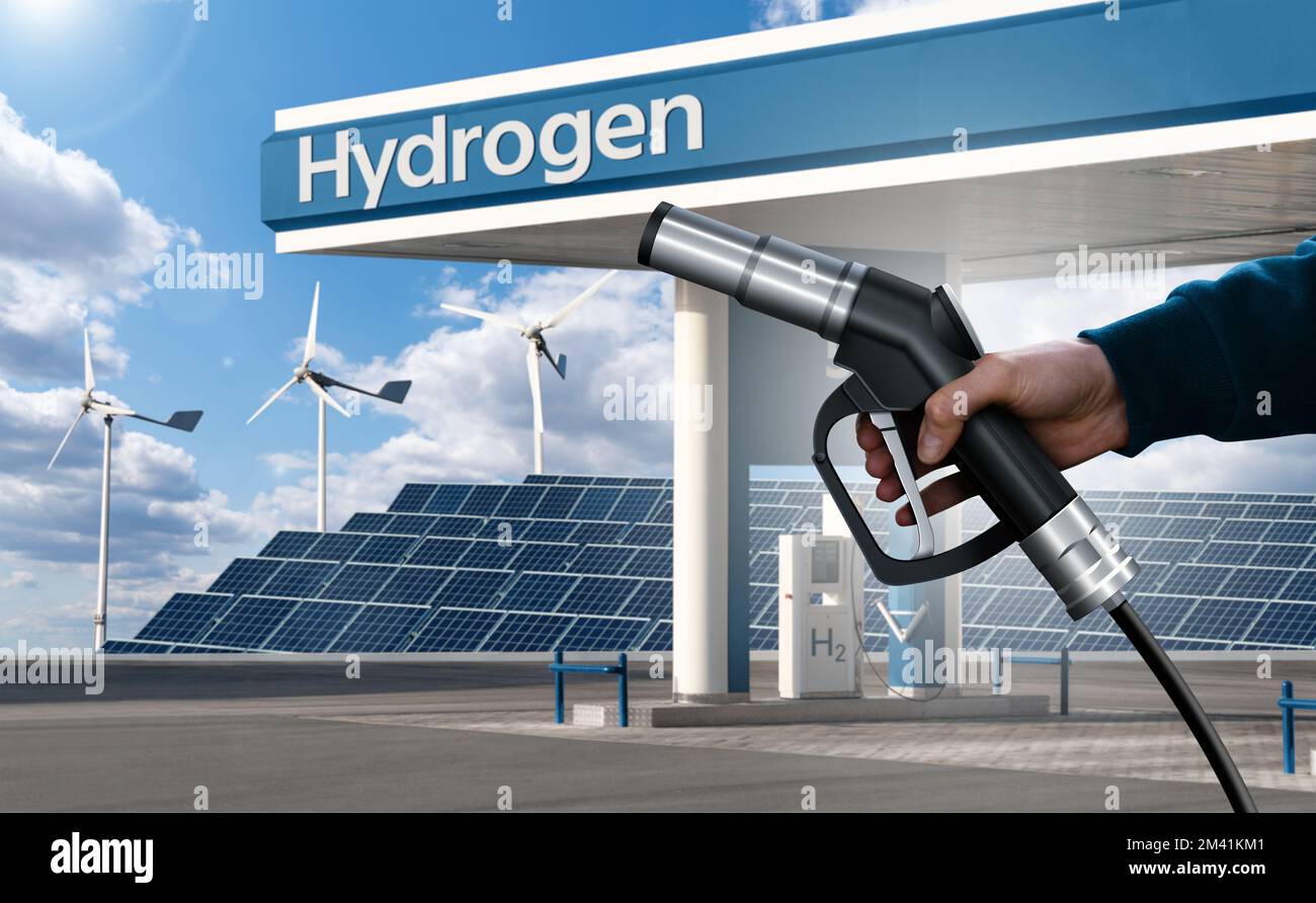 Hand with H2 nozzle on a background of hydrogen filling station using renewable energy. Clean ...