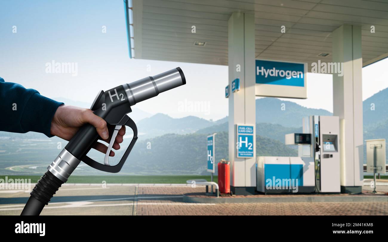 Hand with H2 nozzle on a background of hydrogen filling station. Clean ...