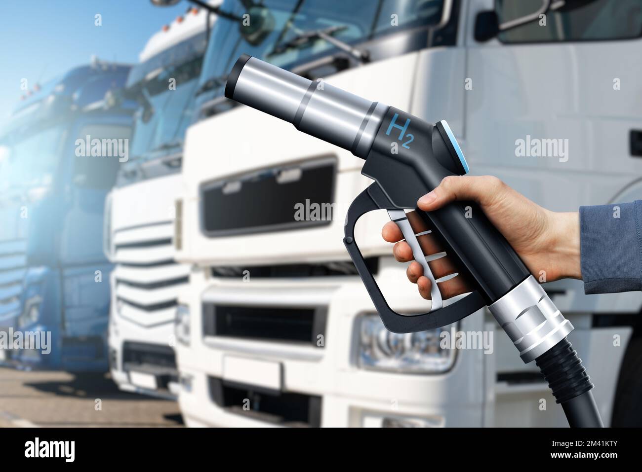 Hand with H2 nozzle on a background of hydrogen fuel cell semi trucks ...