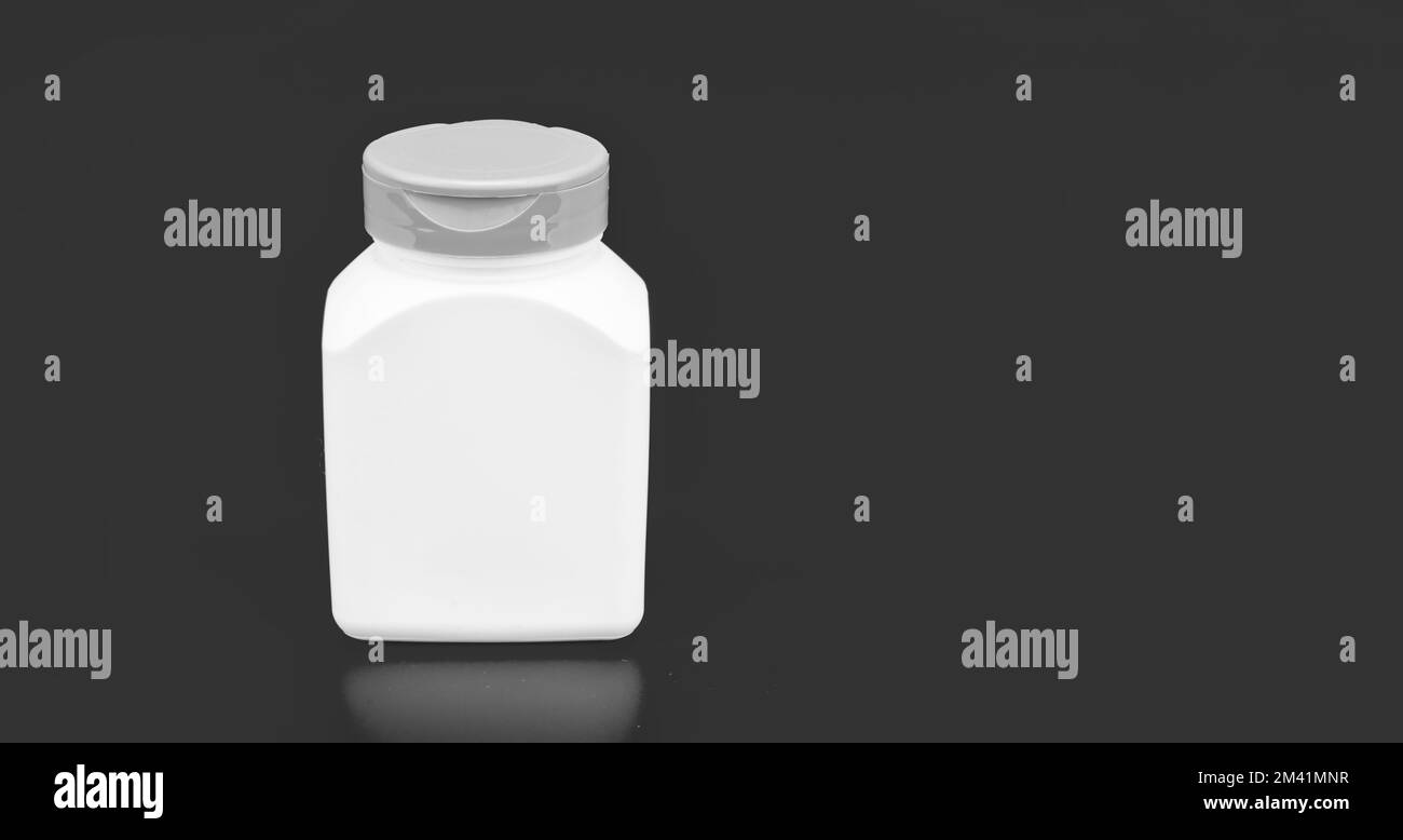 presenting vitamin product. white unbranded pill jar. multivitamin ...