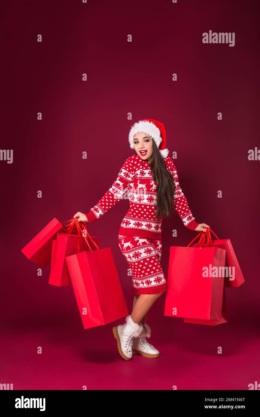 Attractive woman is holding many packages of bought presents with both ...