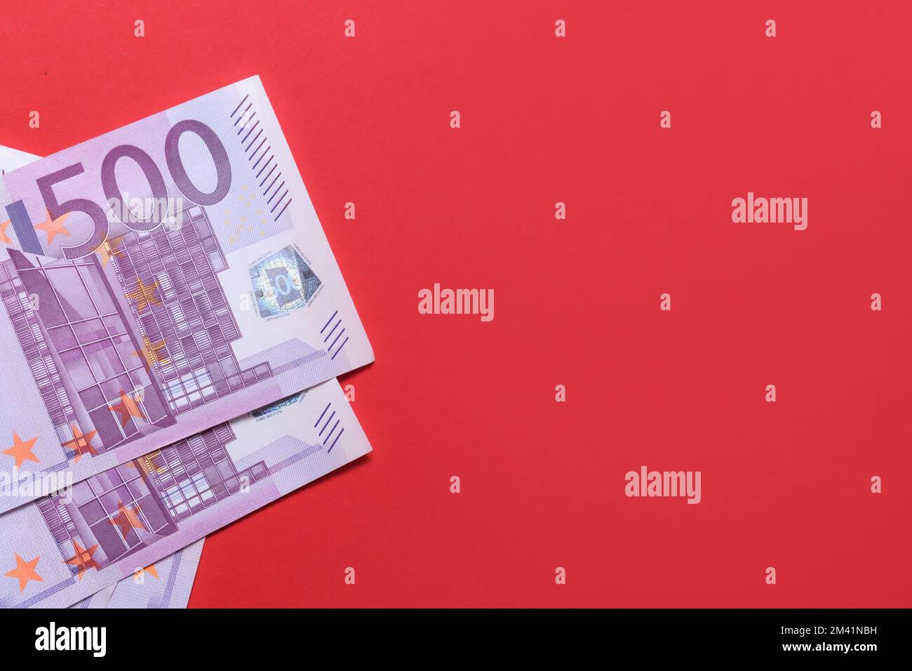 500 euro banknotes on a red background Stock Photo - Alamy