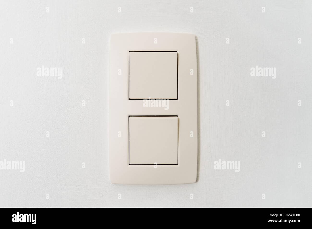 Standard household light switch on a painted white wall after a long ...