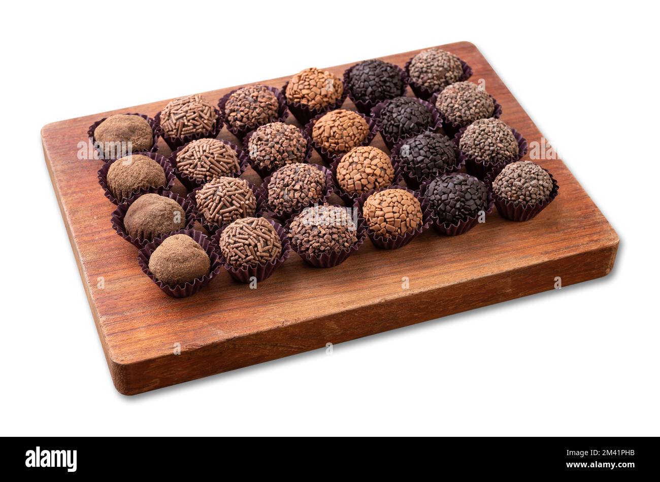 Typical brazilian brigadeiros, various flavors over wooden board ...
