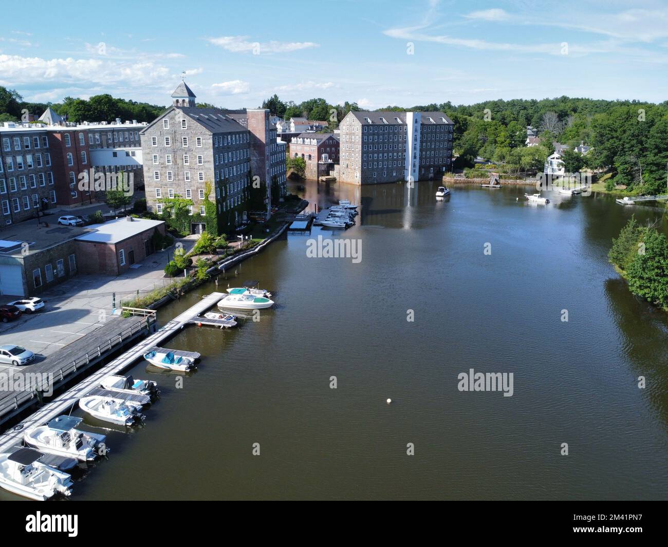 An aerial view of a river through a city with the port at the shore ...