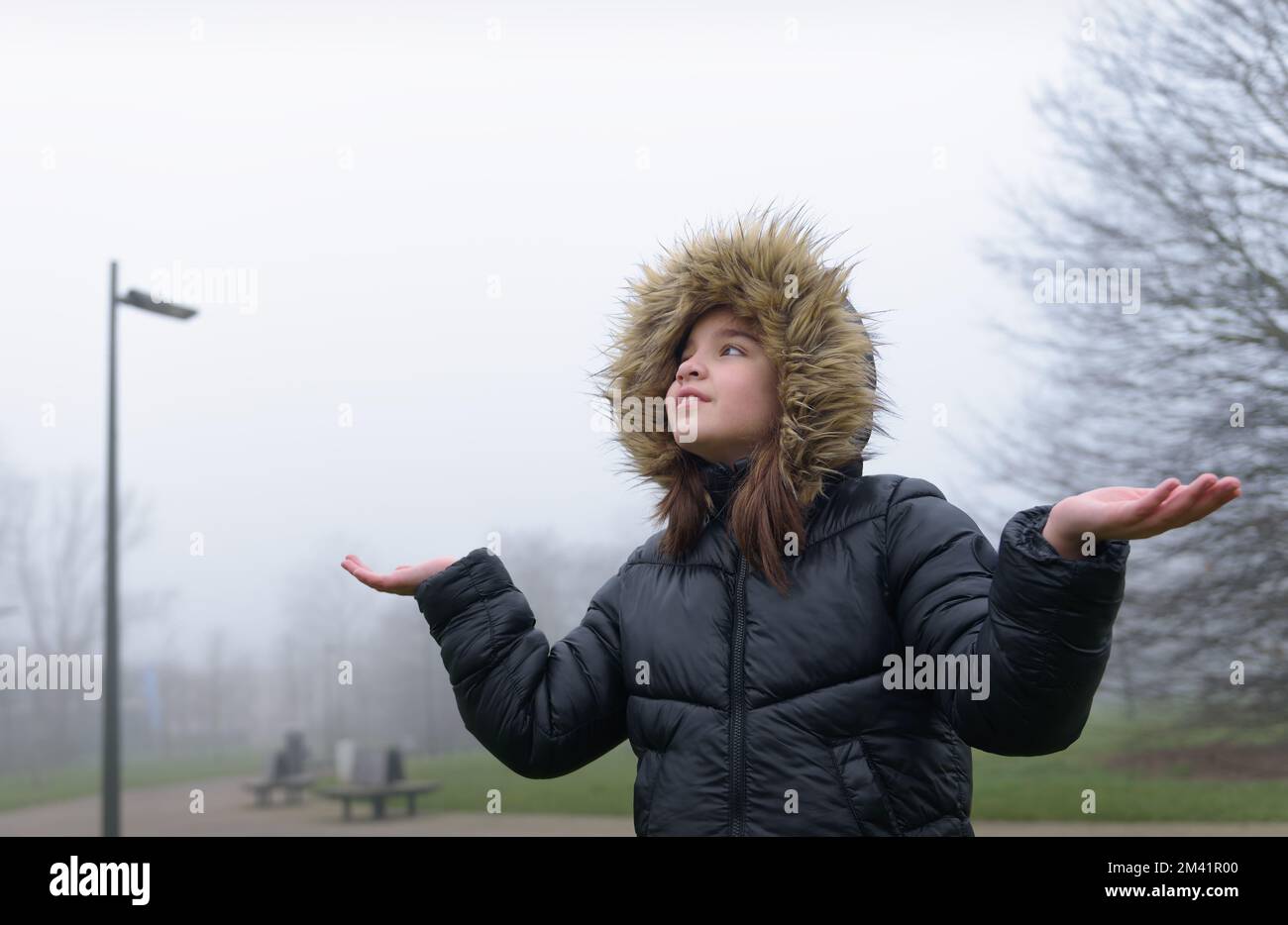 No snow. Winter without snow. Portrait of a teenager girl in the park ...