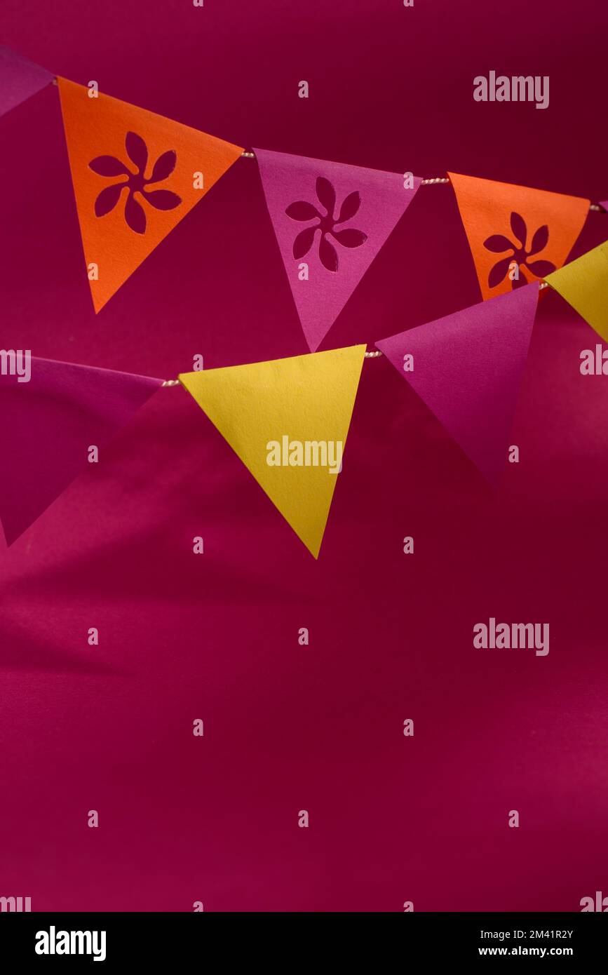 Colorful paper bunting against the Bright magenta background. Paper ...