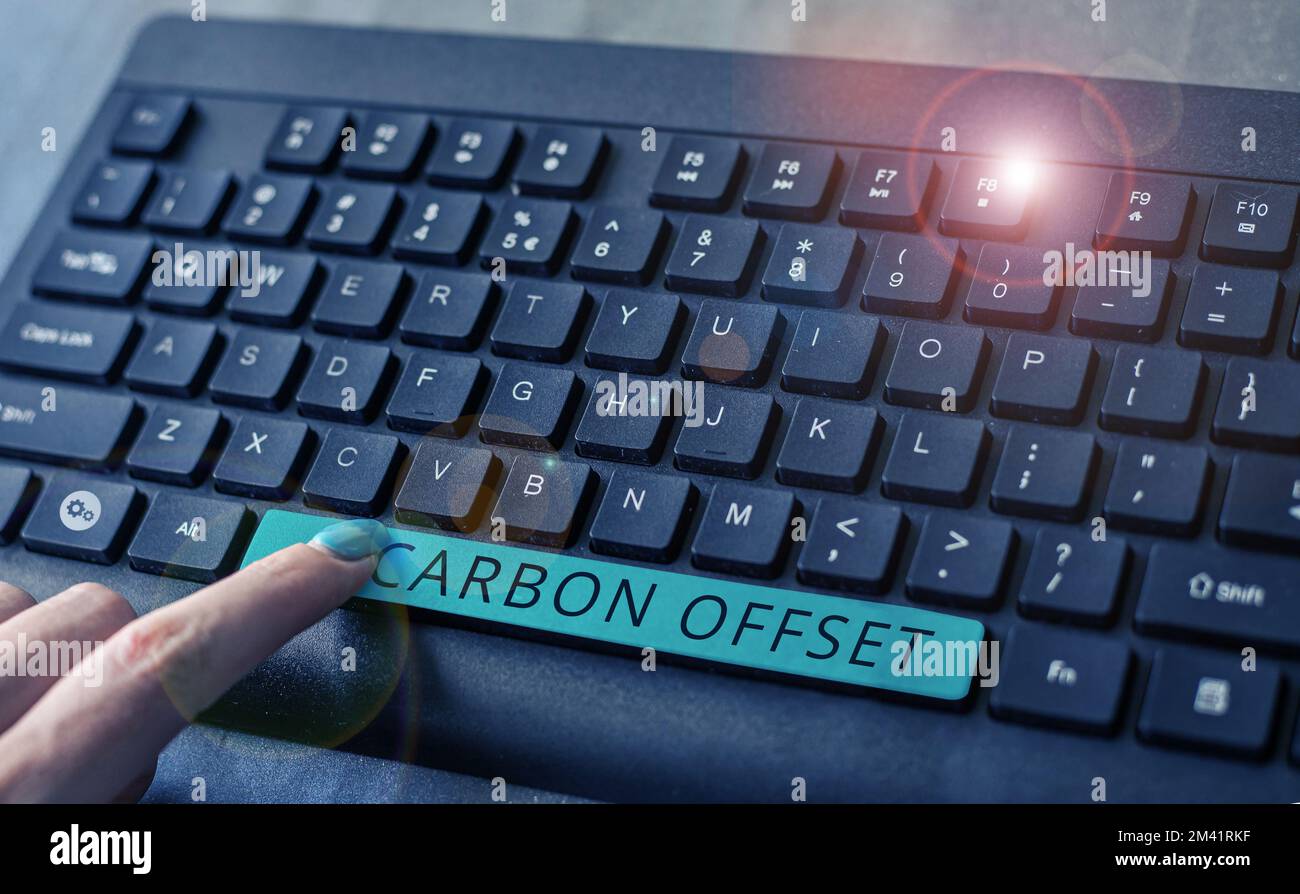 Hand writing sign Carbon Offset. Business overview Reduction in ...