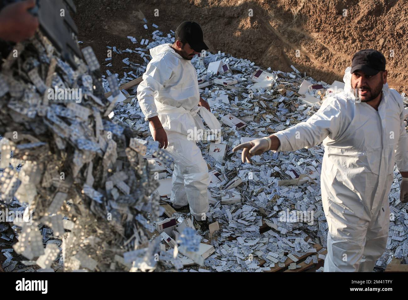 Baghdad, Iraq. 18th Dec, 2022. Workers dump narcotic pills before the ...