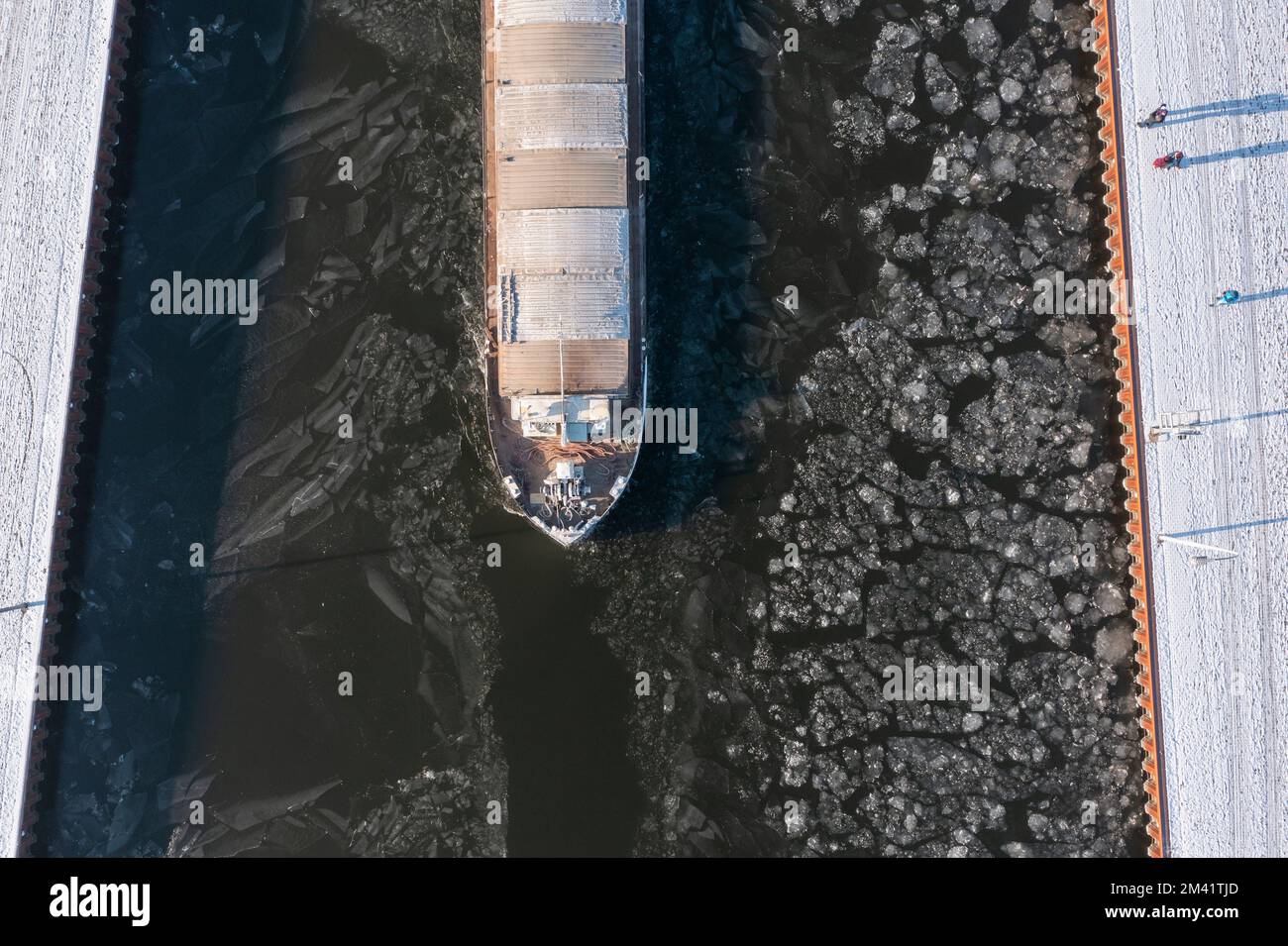 Magdeburg, Germany. 18th Dec, 2022. A barge crosses the icy Magdeburg ...
