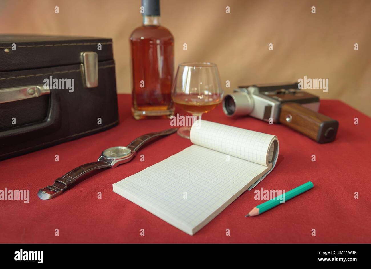 Retro composition - Bottle, glass, wrist watch, notebook and old movie ...