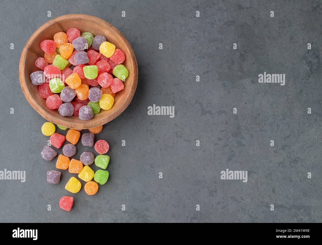 Colorful gum drop candies over stone background with copy space Stock ...