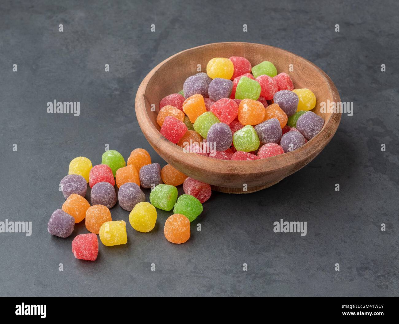Colorful candies on a bowl over stone background Stock Photo - Alamy