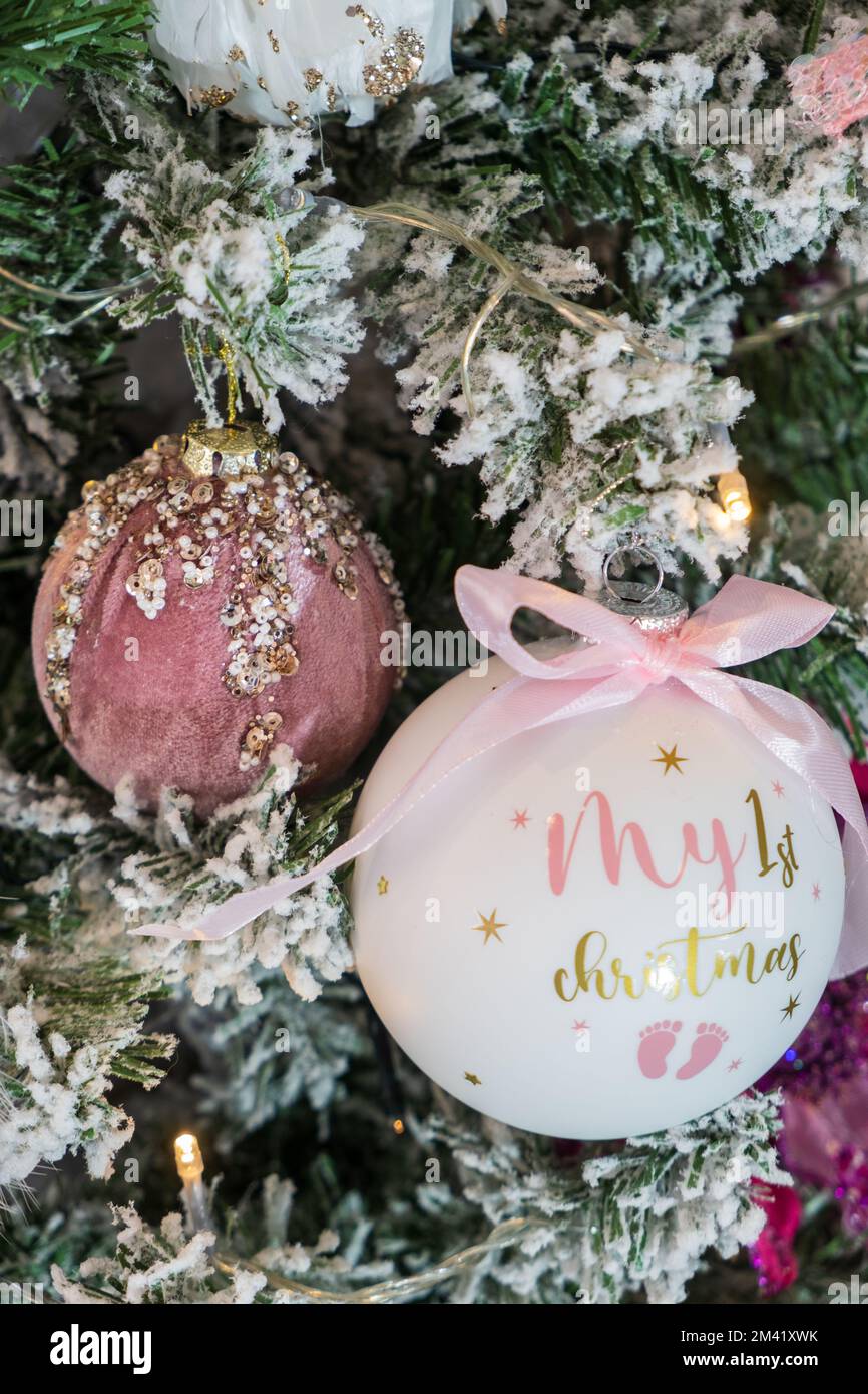 White My First Christmas ball ornament hangs from bough of Christmas ...