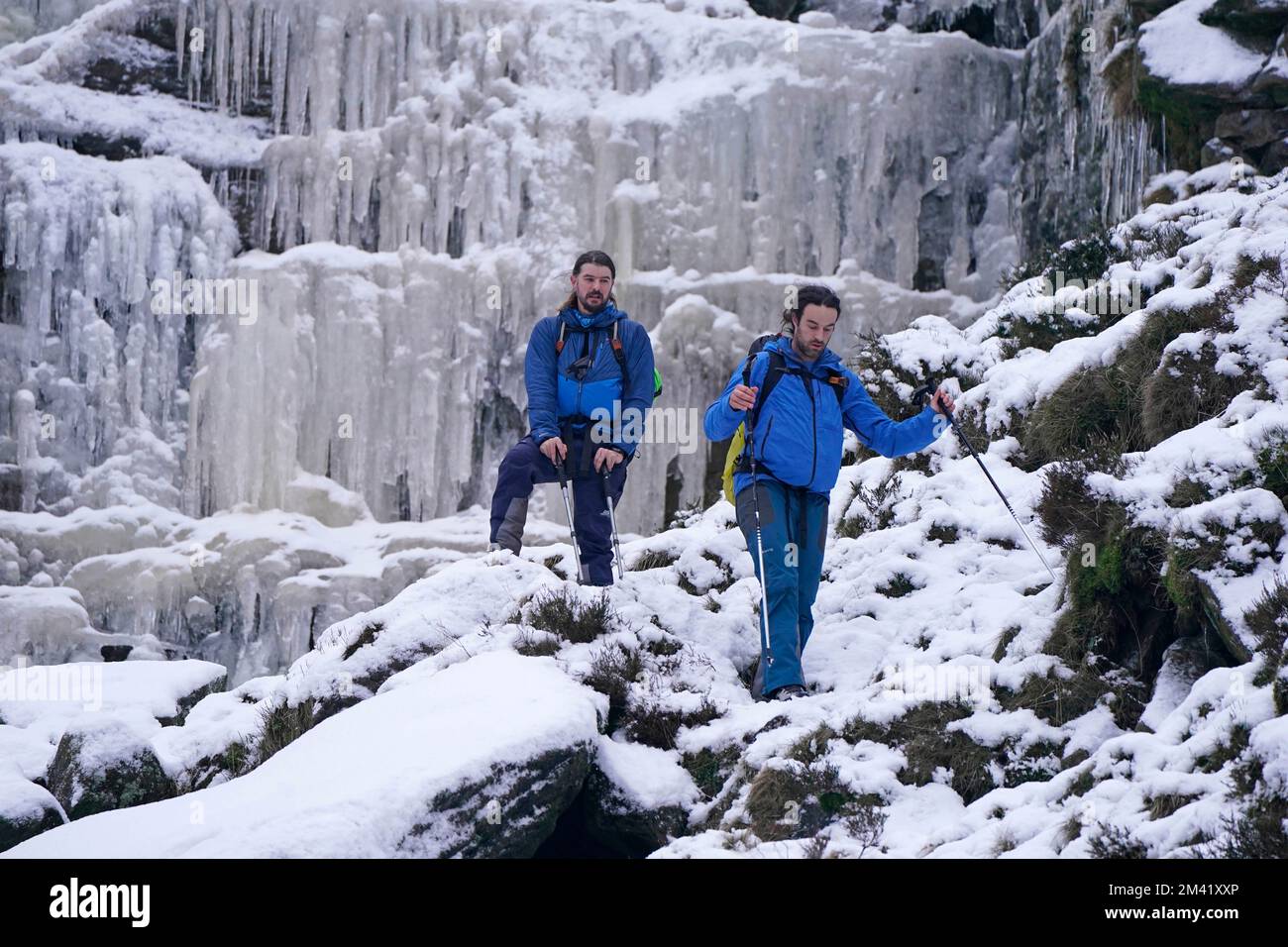 People walking at the frozen Kinder Downfall, High Peak in Derbyshire ...