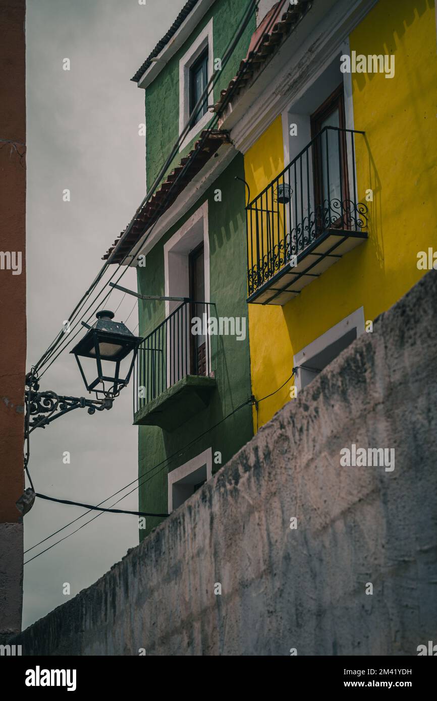 A vertical shot of green and yellow walled residential buildings Stock ...