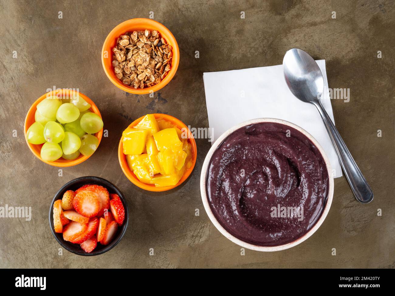 Açaí on a bowl with strawberry, mango and grape on colorful bowls over ...