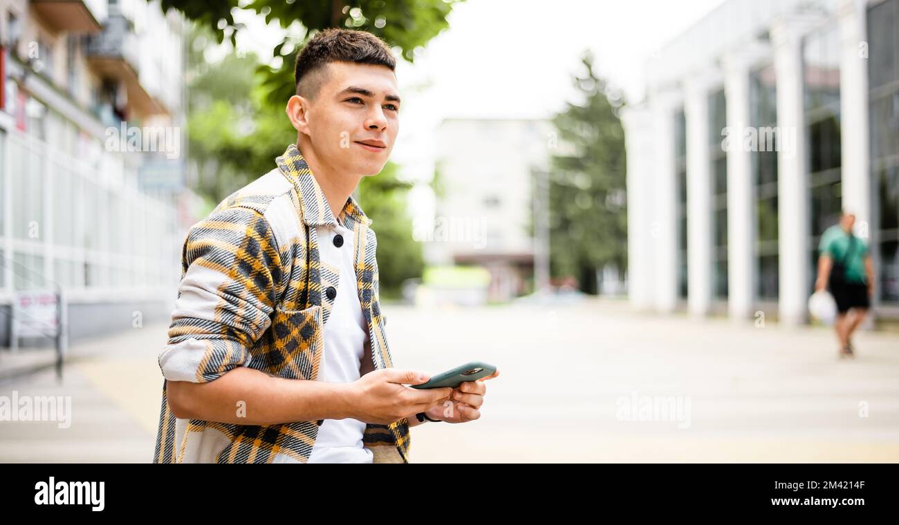 The guy uses the phone on the street Stock Photo - Alamy