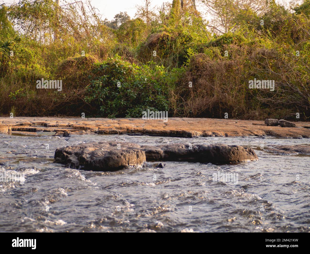 A large rock in the middle of the river Stock Photo - Alamy