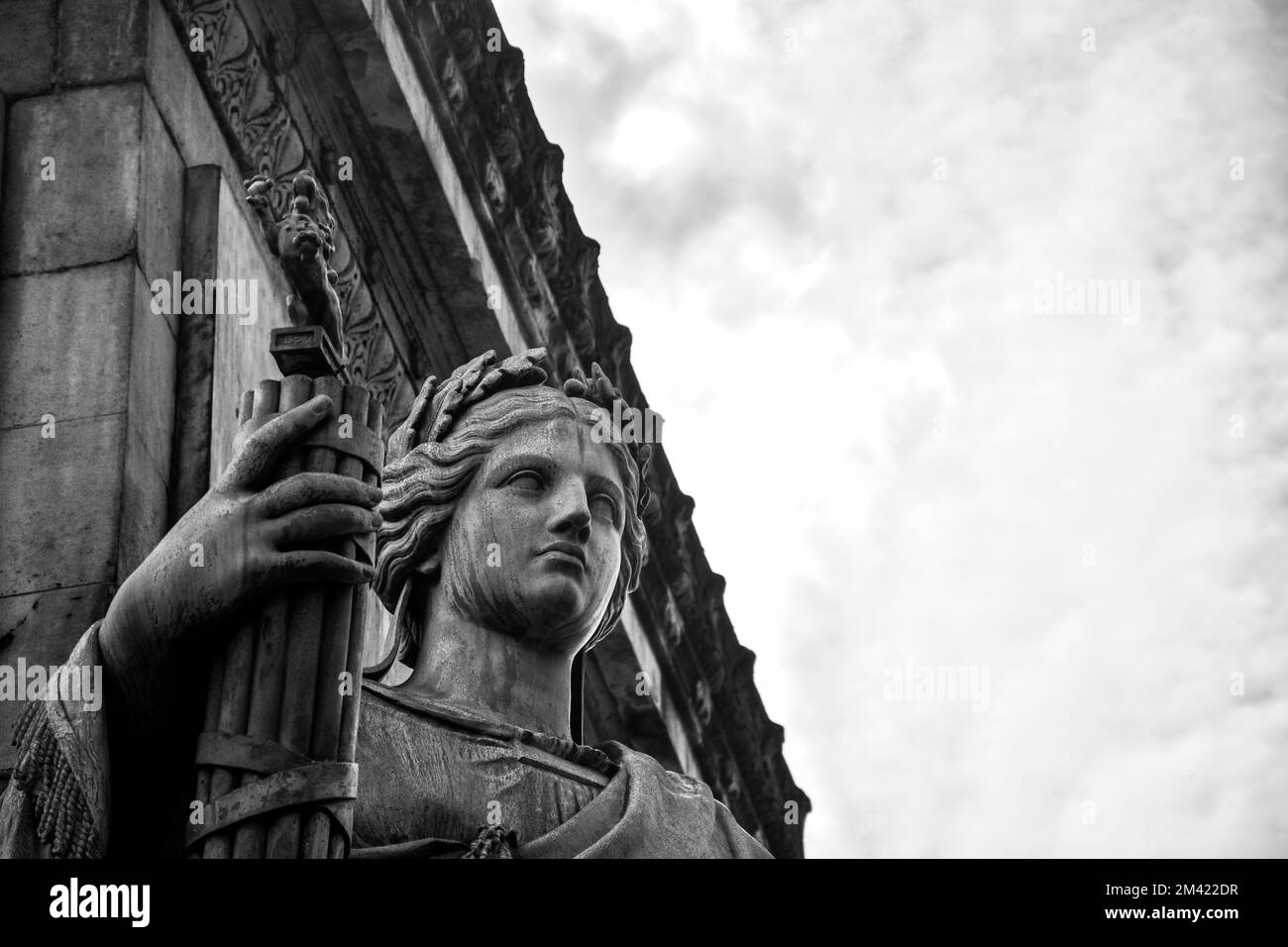A grayscale of the male statue under a cloudy sky Stock Photo - Alamy