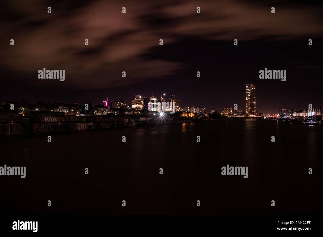 A scenic view of a coastal city skyline during nightime Stock Photo - Alamy