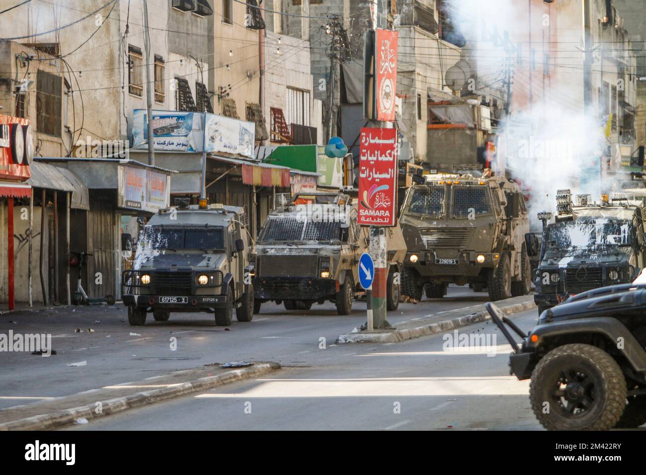 Israeli army forces fire tear gas canisters during their withdrawal ...