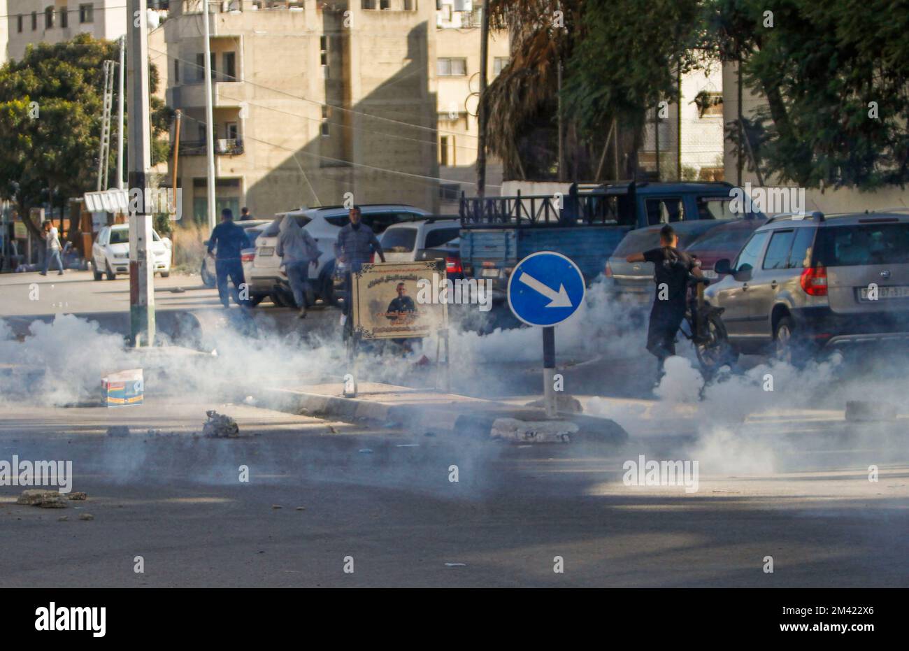 A Palestinian flees to hide from tear gas fired by the Israeli army at ...