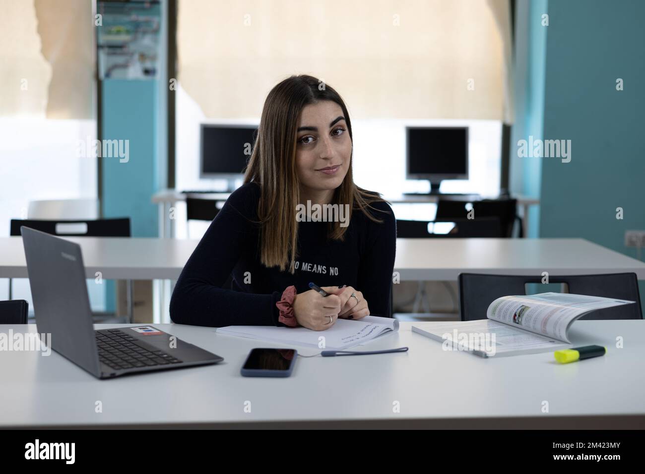 Student in classroom writing notes Stock Photo - Alamy