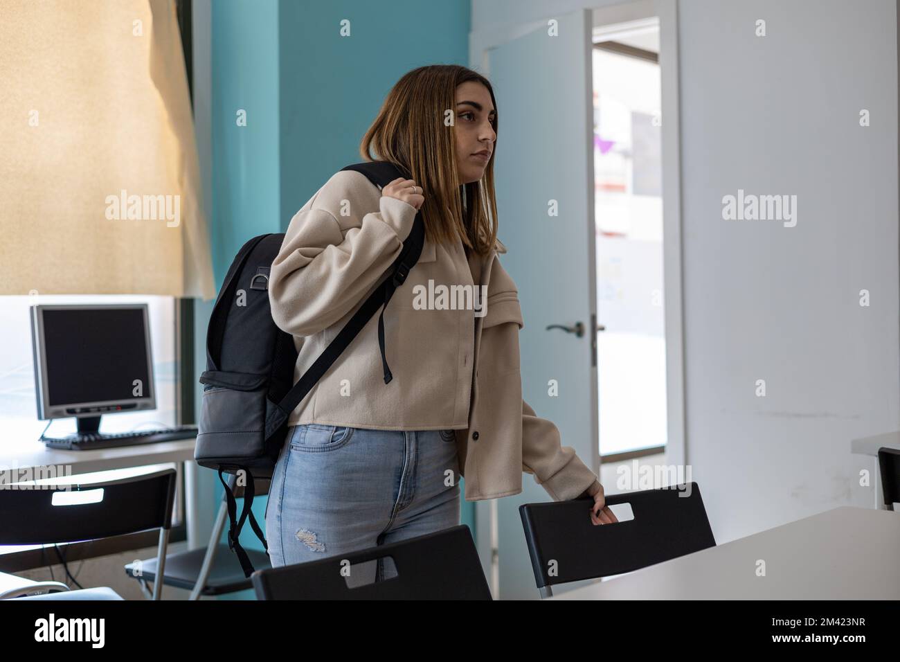 female college student with backpack in classroom Stock Photo - Alamy
