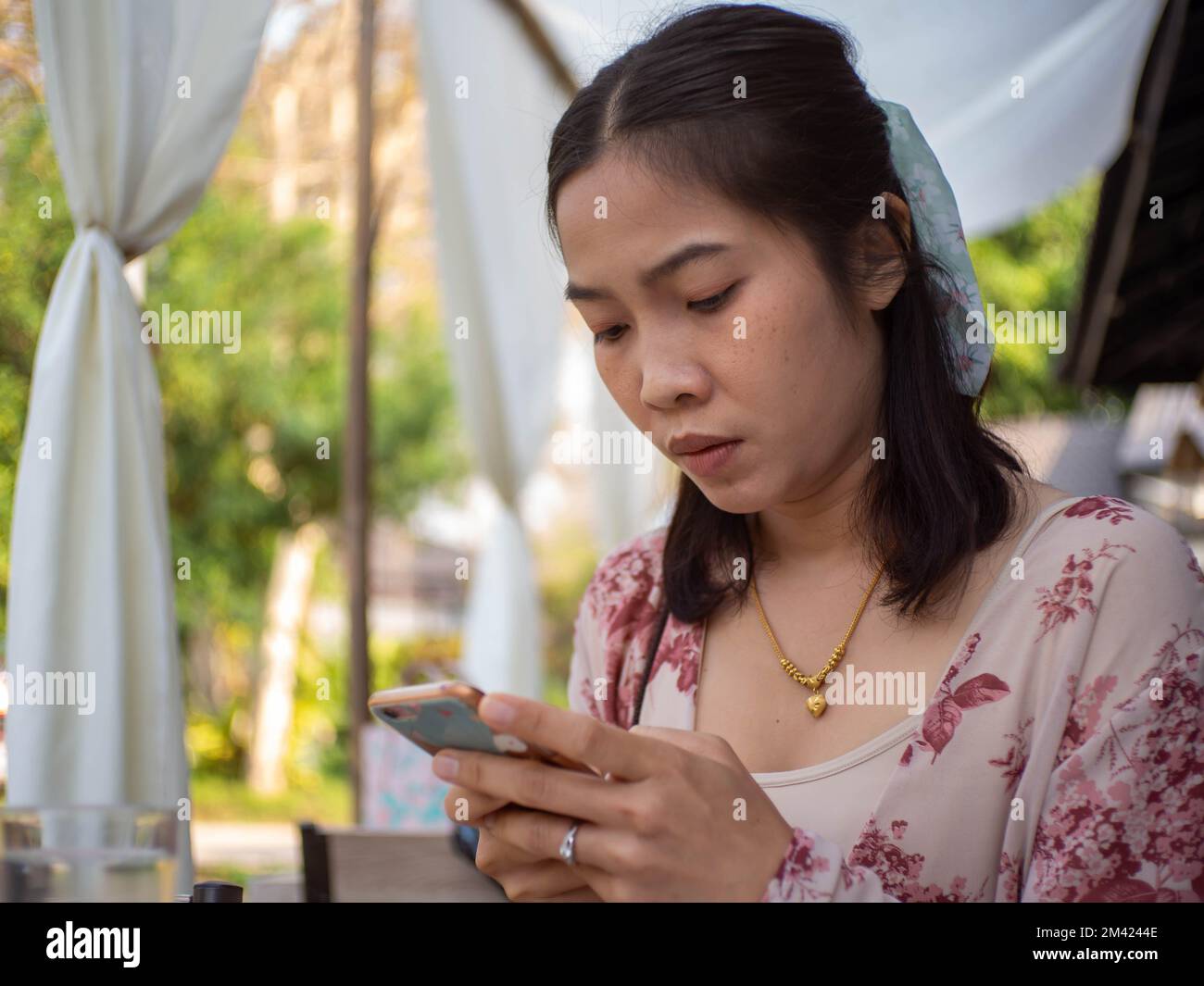 A woman wearing a red dress in a coffee shop atmosphere at coffee shop called "Nature Park ...