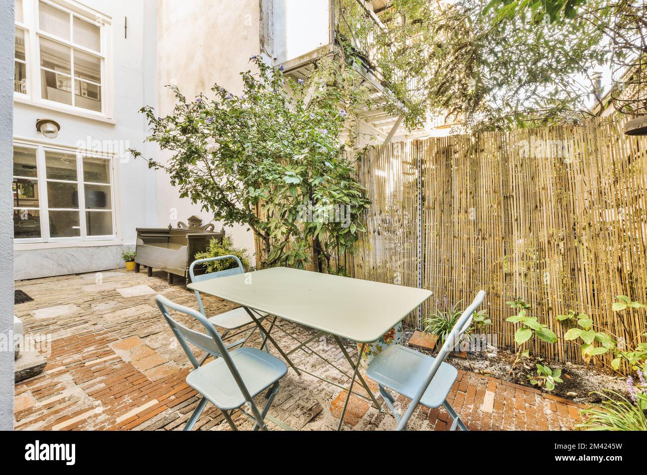 an outdoor patio with table and chairs in the back yard, next to a ...