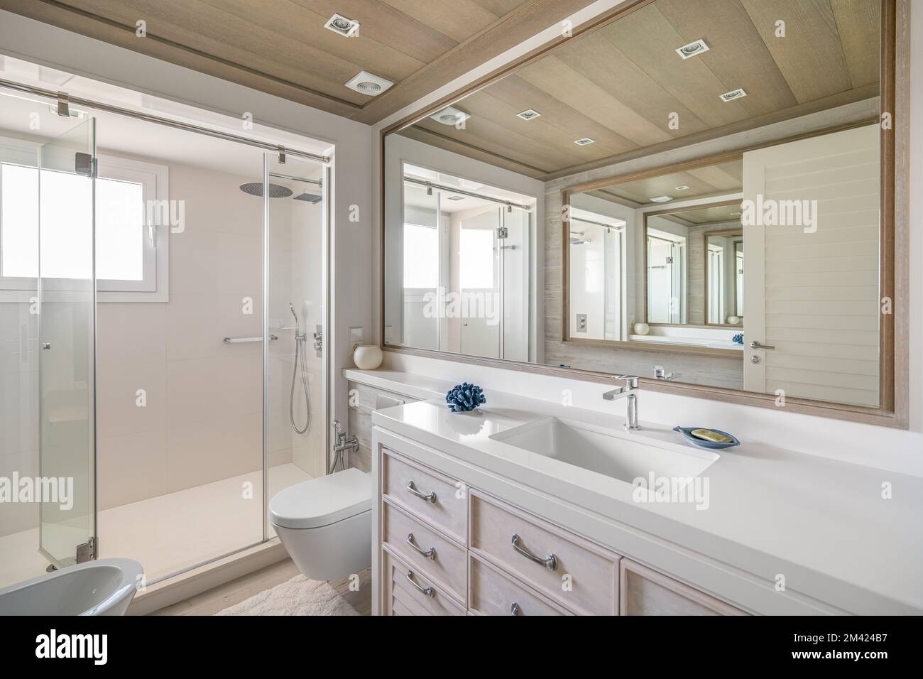 Luxurious bathroom with a large mirror with an unusual multiple ...