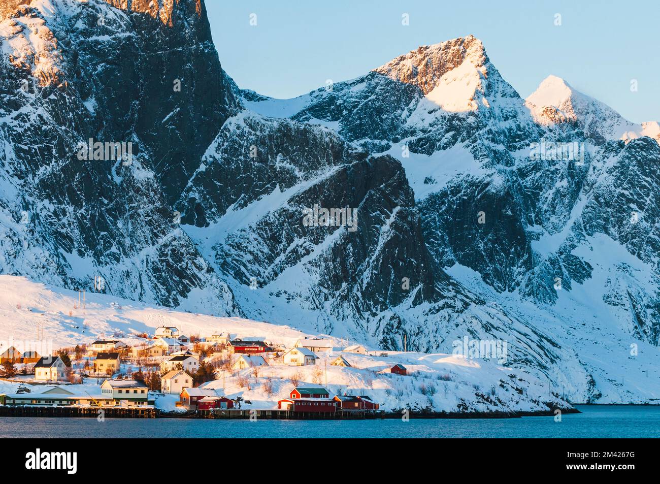 Buildings in front of snow covered mountain landscape Stock Photo - Alamy