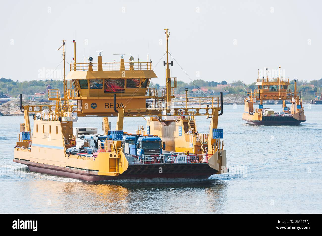Yellow road ferry carry vehicles, Sweden Stock Photo - Alamy