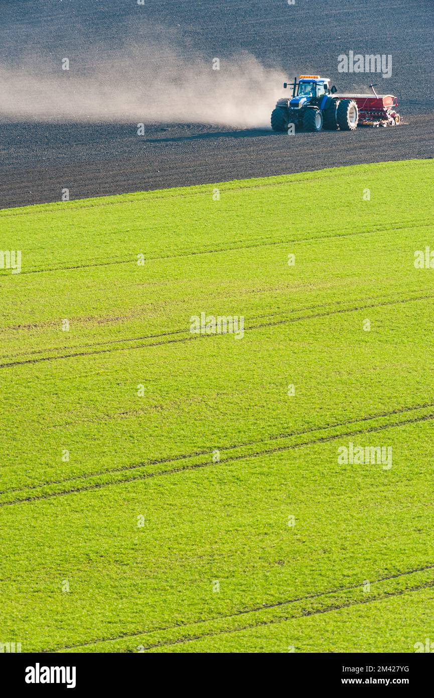 Tractor ploughing soil in a field Stock Photo - Alamy
