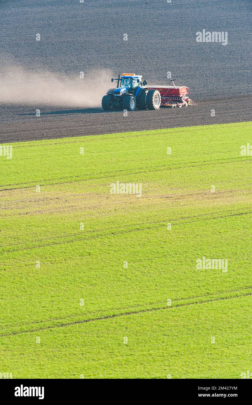 Tractor ploughing soil in a field Stock Photo - Alamy