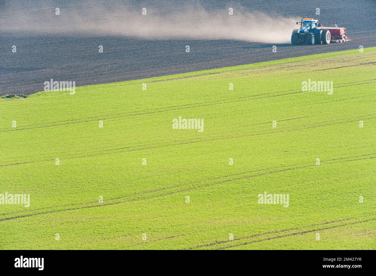 Tractor ploughing soil in a field Stock Photo - Alamy