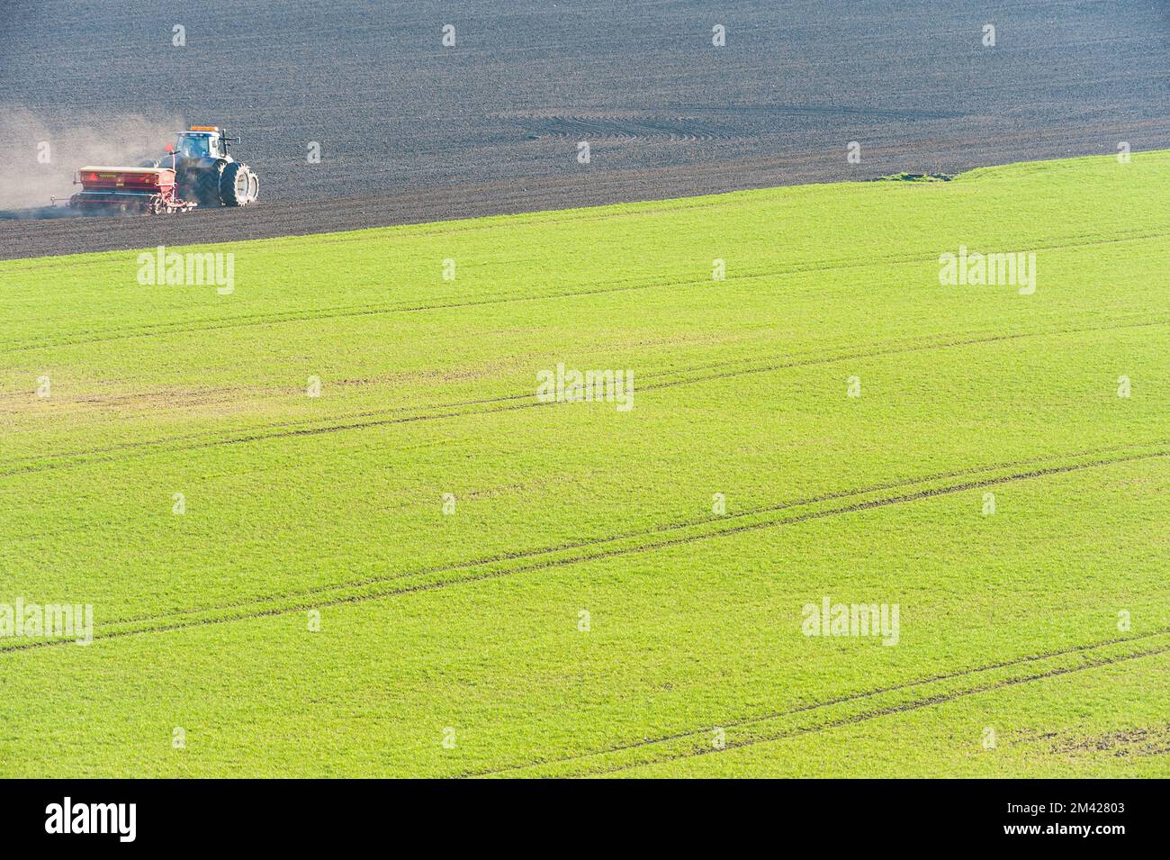Tractor ploughing soil in a field Stock Photo - Alamy