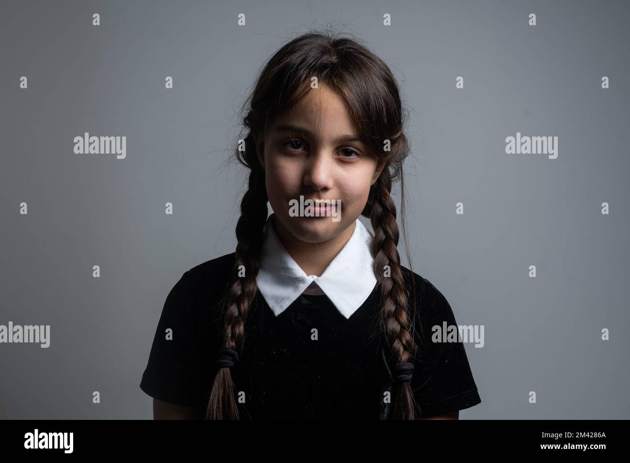 a girl in a Wednesday Addams costume style Stock Photo - Alamy