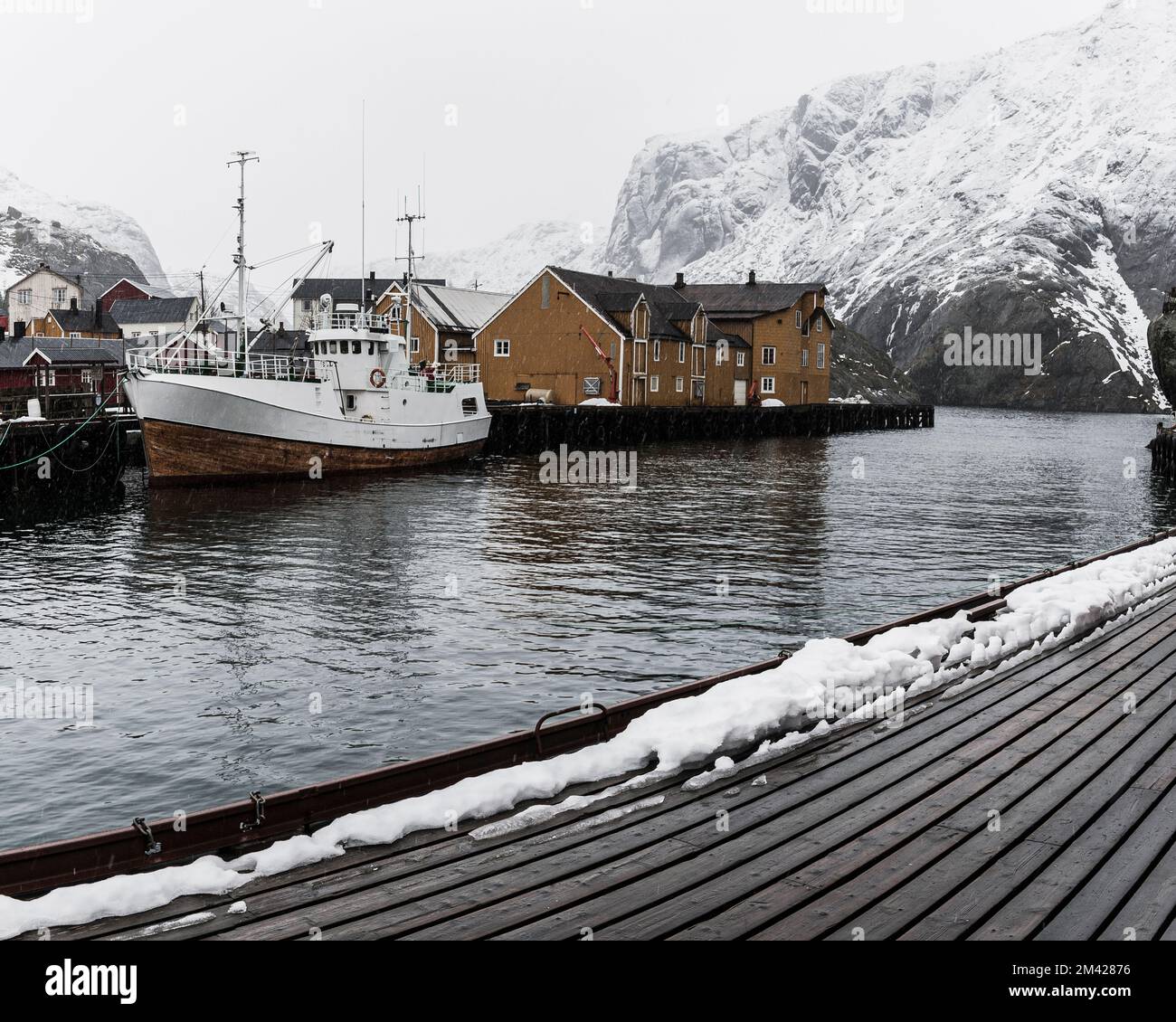 Fishing boat at harbor during snowfall, Norway Stock Photo - Alamy