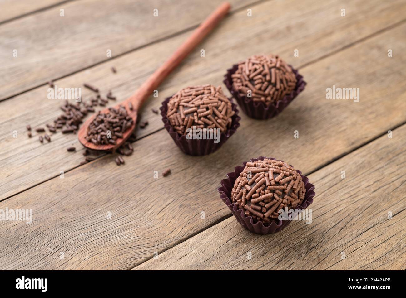 Typical brazilian chocolate brigadeiros over wooden table Stock Photo ...