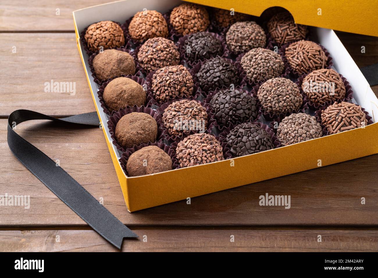 Typical brazilian brigadeiros, various flavors in an open gift box ...