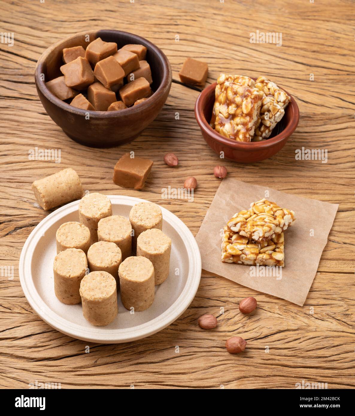 Typical brazilian candies over wooden table. Doce de leite or dulce de ...