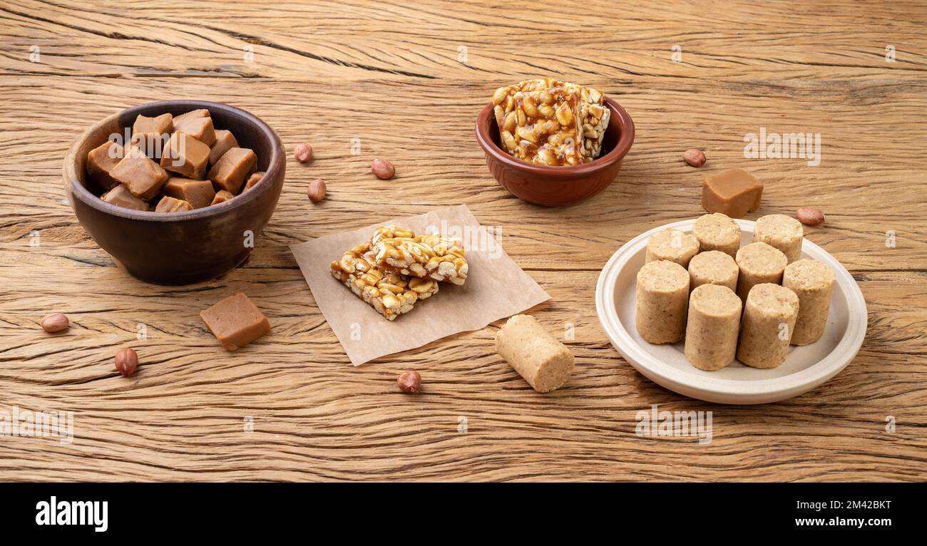 Typical brazilian candies over wooden table. Doce de leite or dulce de ...