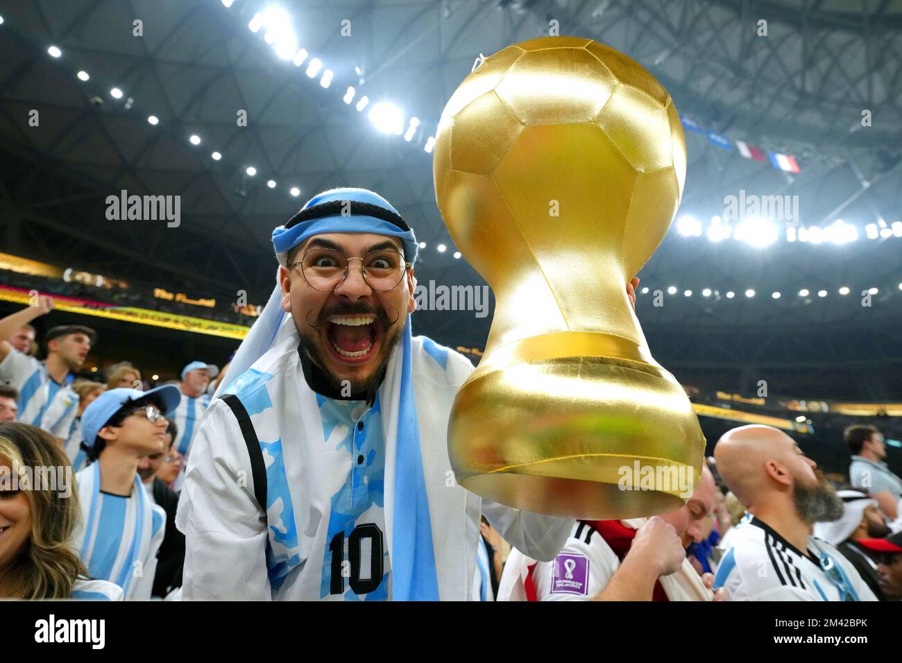 An Argentina fan holds a replica of the FIFA World Cup trophy ahead of ...